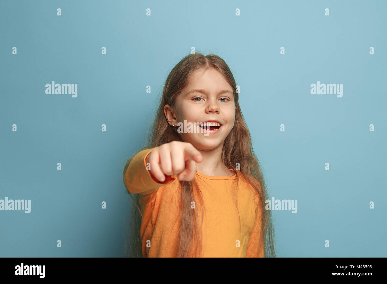 The determination. Teen girl on a blue background. Facial expressions ...