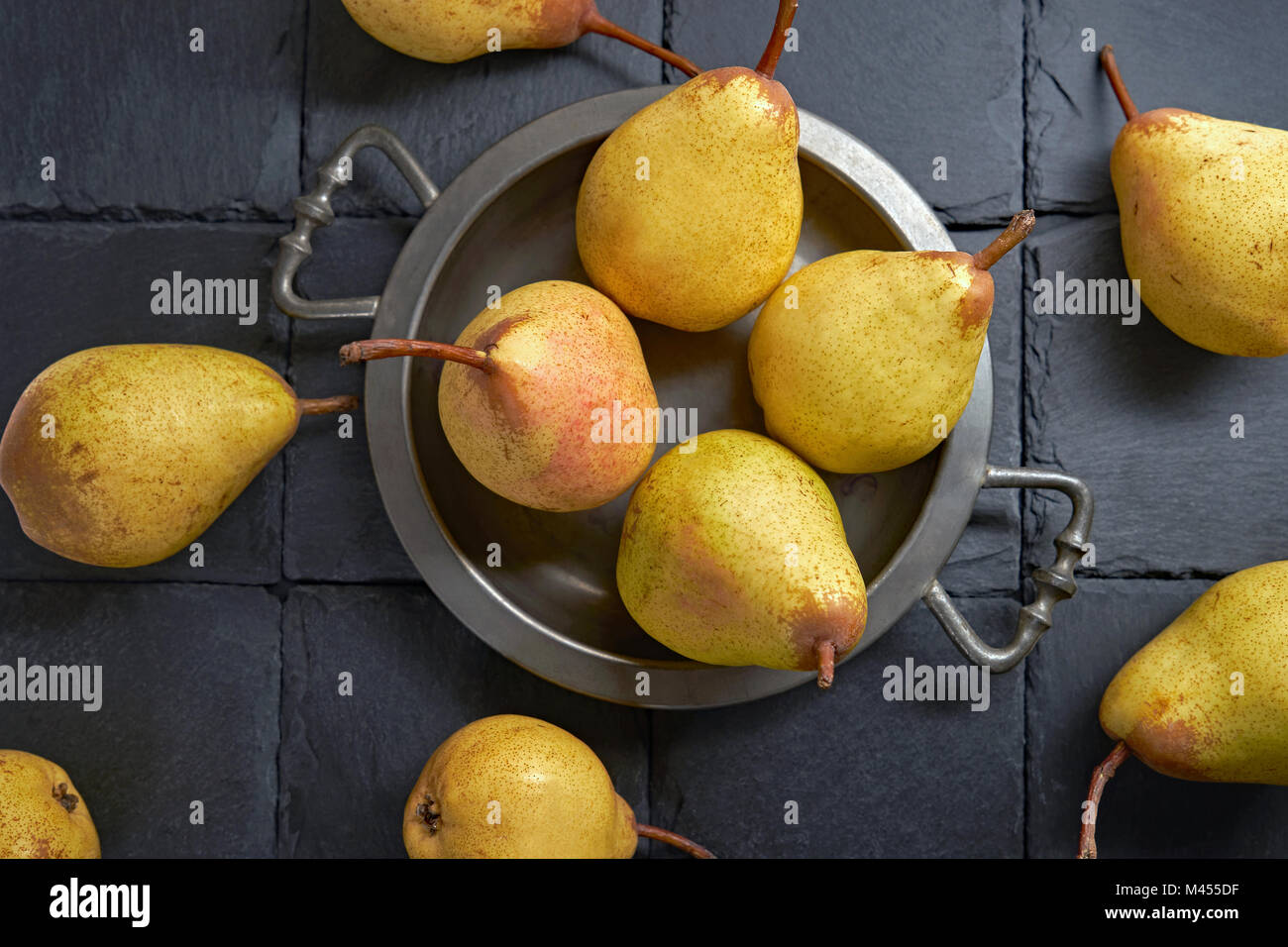 Ripe pears on a black slate stone Stock Photo - Alamy