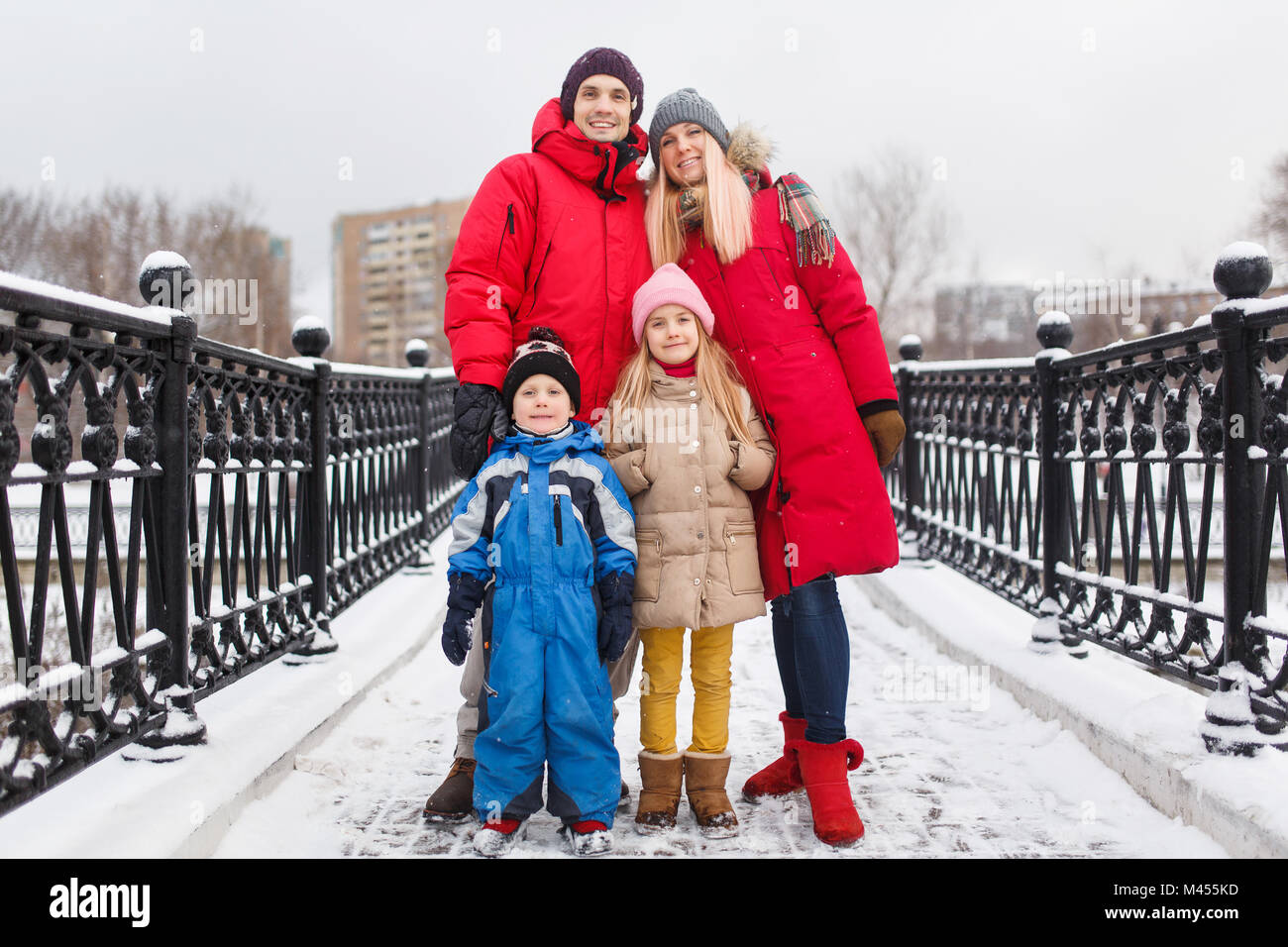 Image of family with children in winter on walk at bridge Stock Photo ...