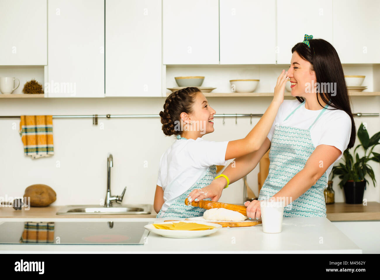 happy mother and daughter cooking at the kitchen Stock Photo - Alamy