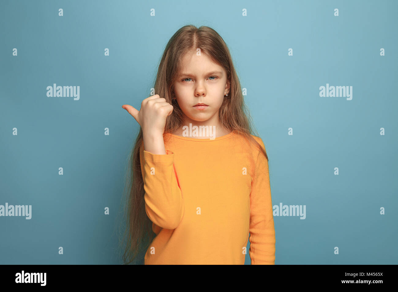 The determination. Teen girl on a blue background. Facial expressions ...