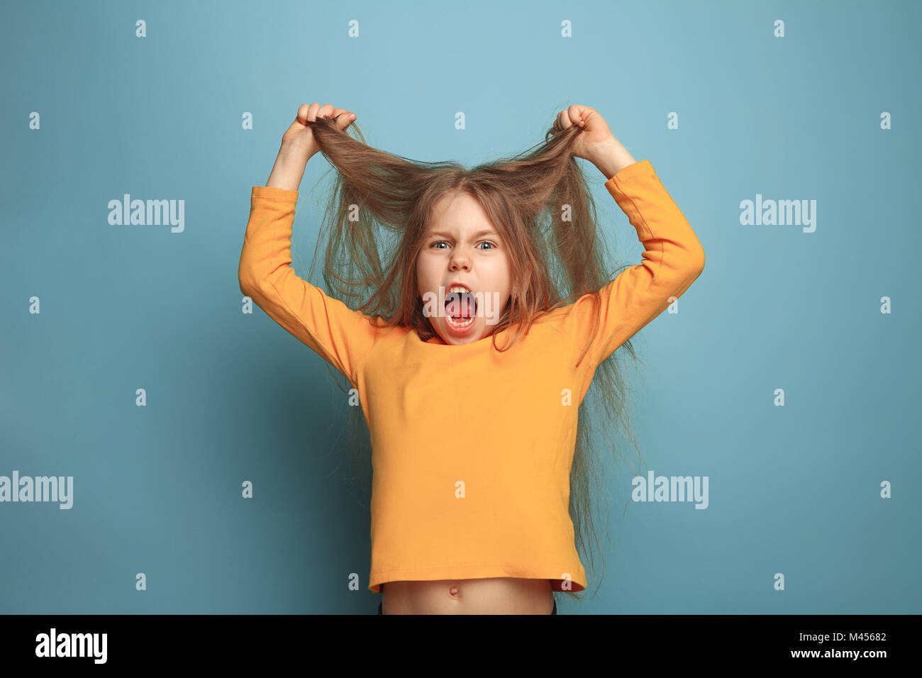 The surprise. Teen girl on a blue background. Facial expressions and ...