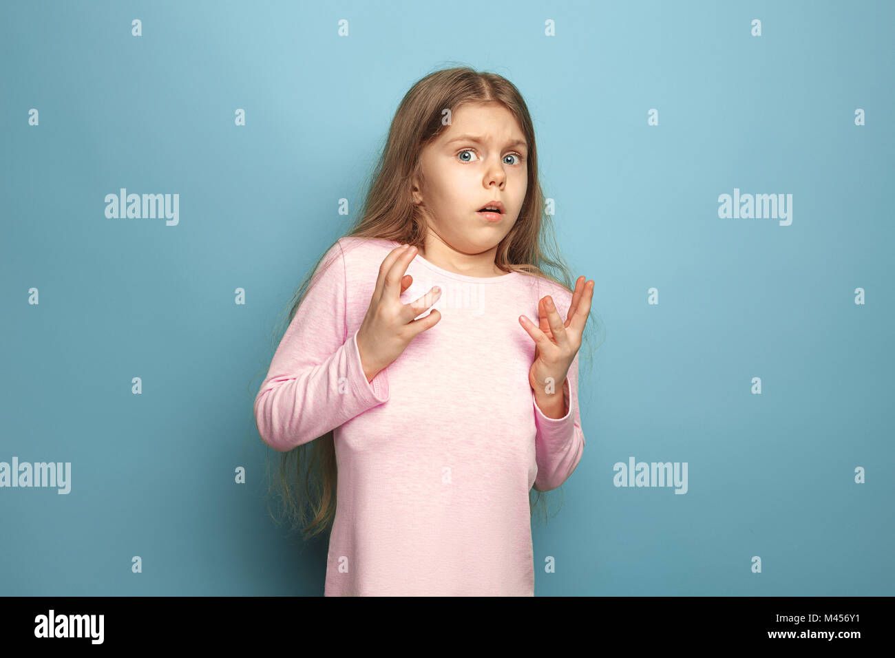 The fear. Teen girl on a blue background. Facial expressions and people ...