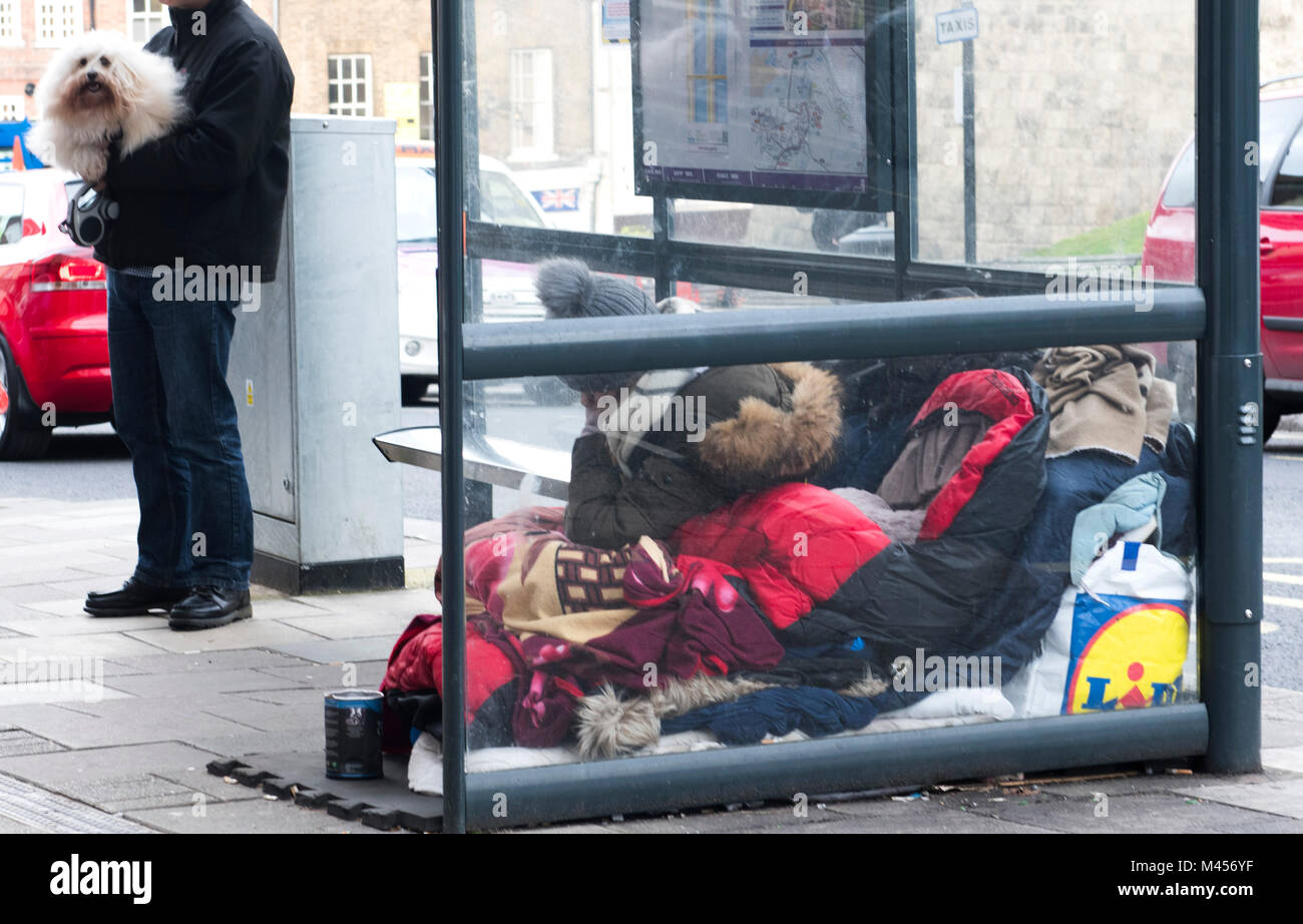 Homeless person sleeping in a bus shelter Windsor, Berks. opposite the ...