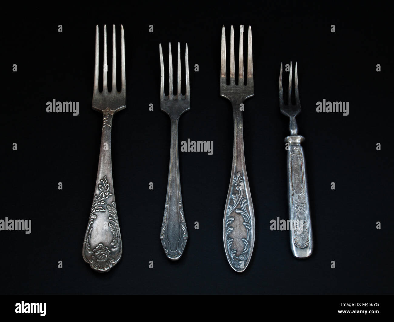 Metal old forks with a pattern and engraving of different size and ...