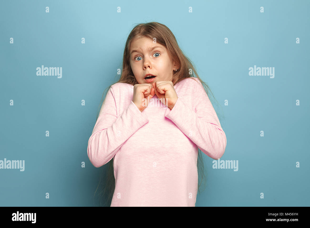 The fear. Teen girl on a blue background. Facial expressions and people ...