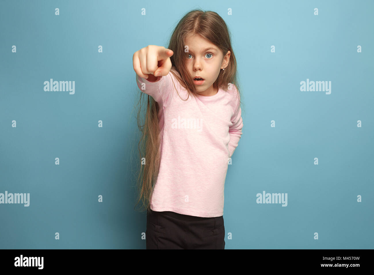 The determination. Teen girl on a blue background. Facial expressions and people emotions ...