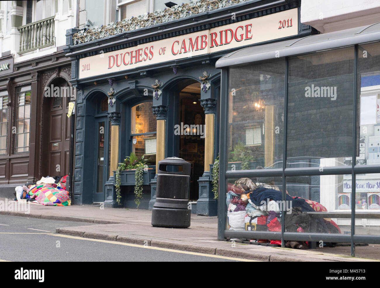 Homeless person sleeping in a bus shelter Windsor, Berks. opposite the ...