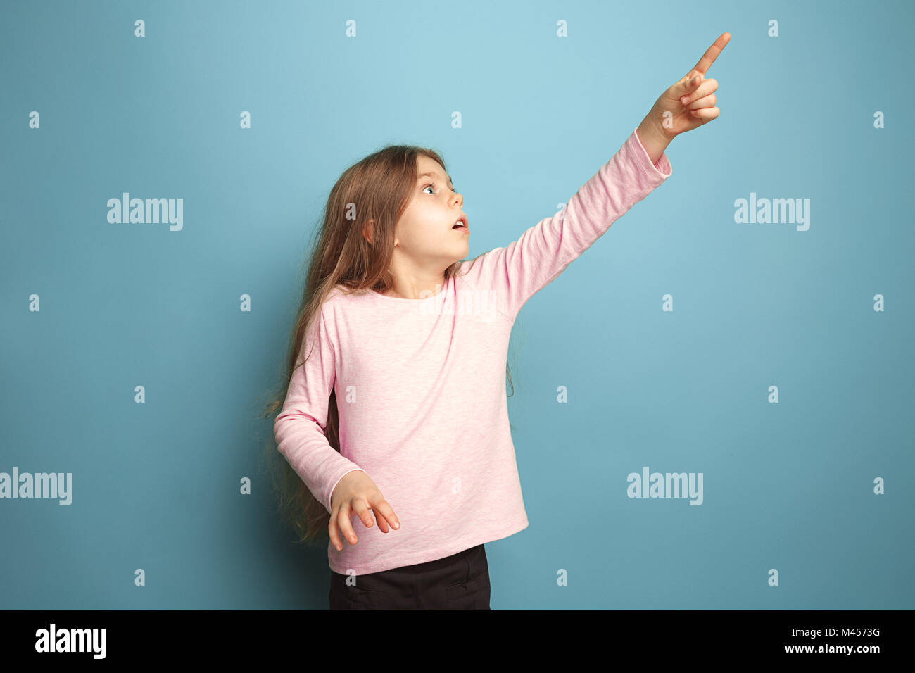 The determination. Teen girl on a blue background. Facial expressions ...