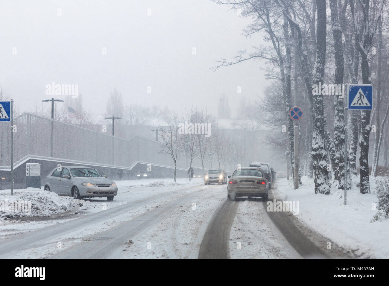 City street under snow during heavy blizzard in winter. Poor snow ...