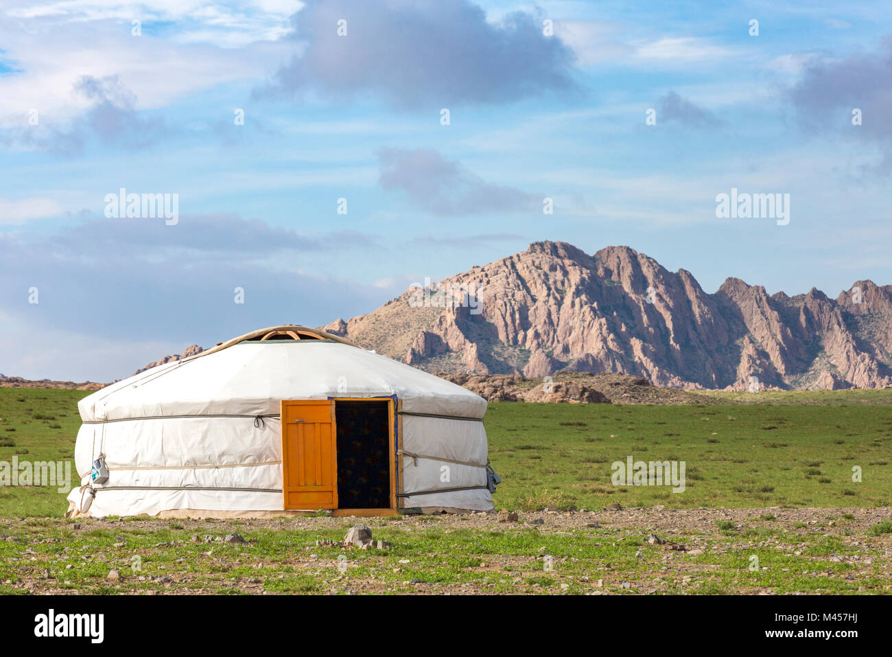 Mongolian ger in the countryside and mountains in the background ...