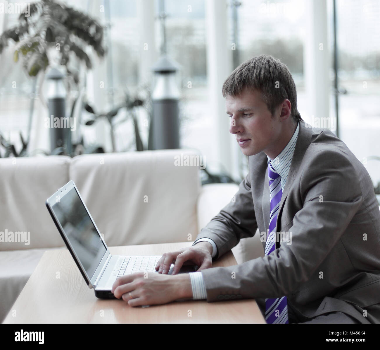Young employee looking at computer monitor during working day Stock ...