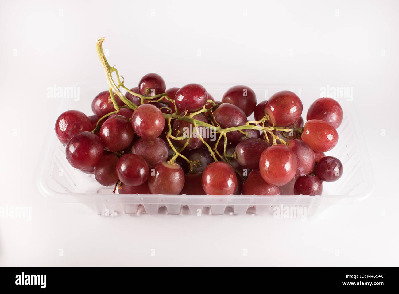 red grapes in plastic container isolated on white background Stock ...