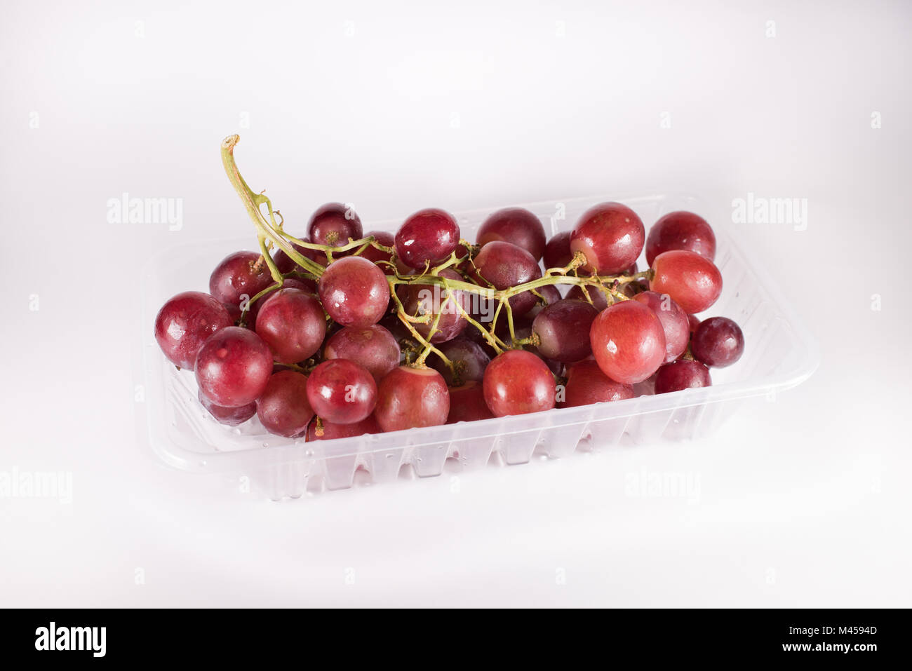 red grapes in plastic container isolated on white background Stock ...