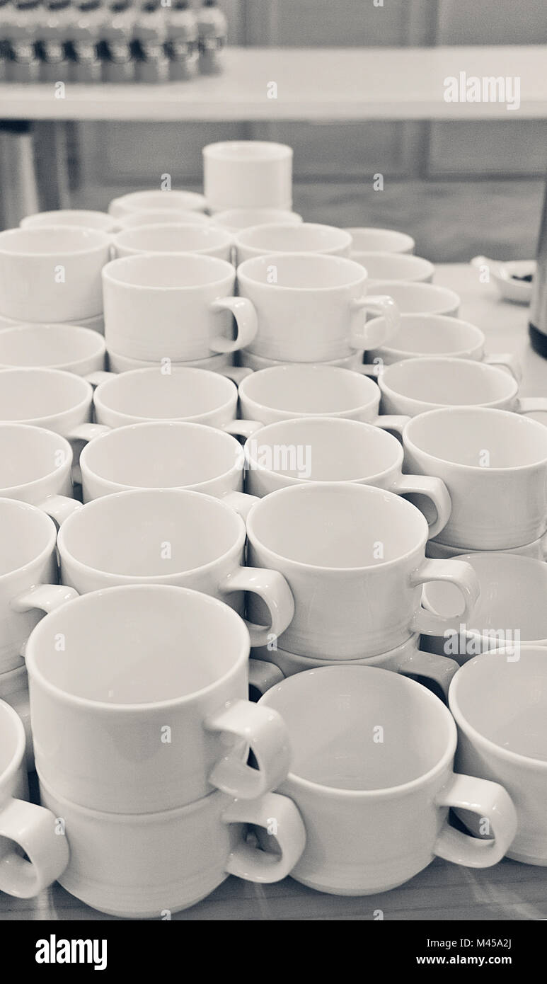 A lot of empty white porcelain cups on the table Stock Photo - Alamy