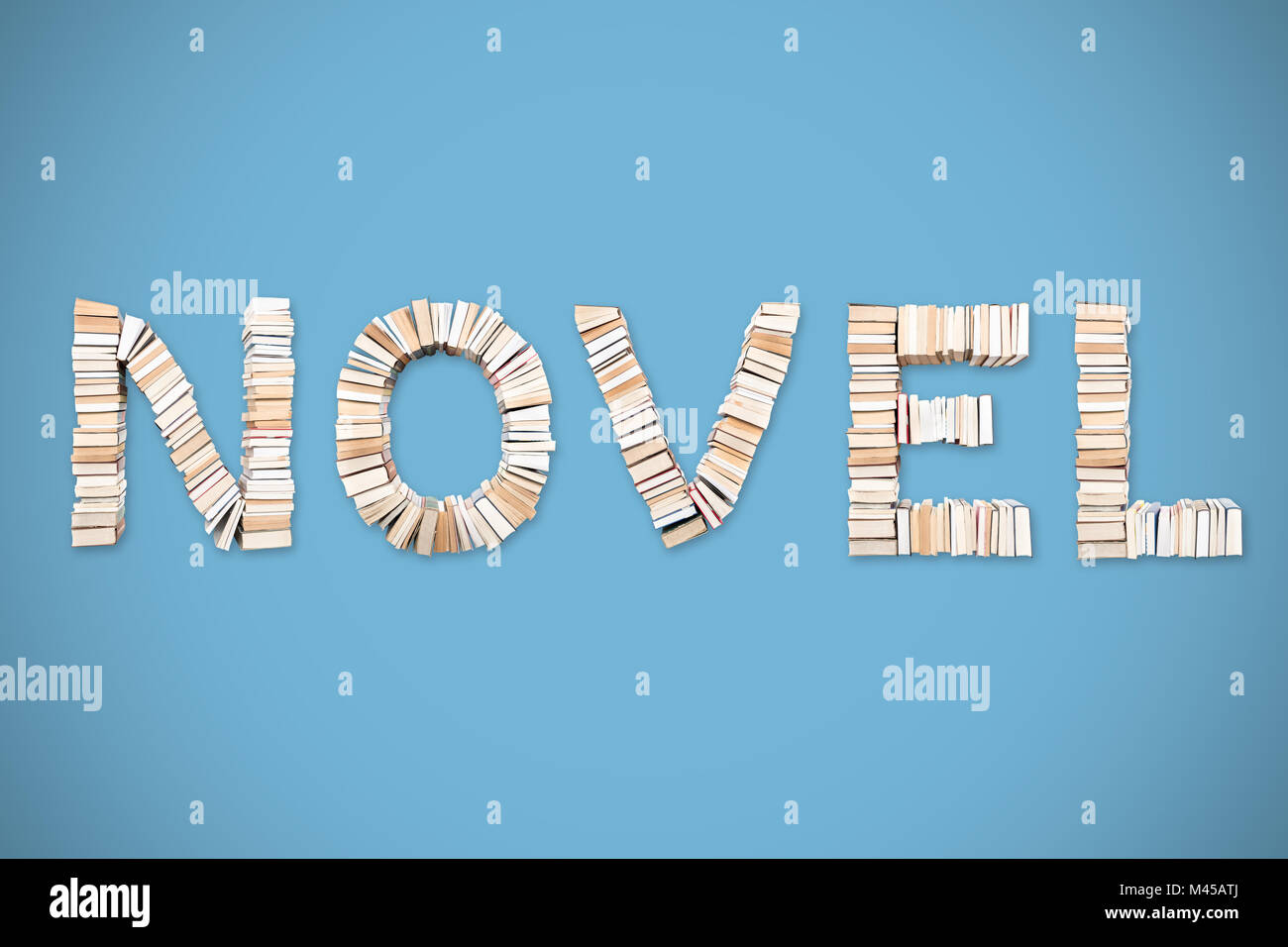 NOVEL word formed from books, shot from above on light blue background ...