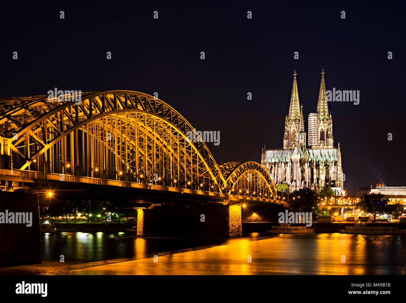 The famous Cologne Cathedral and the Hohenzollern Bridge at night Stock ...