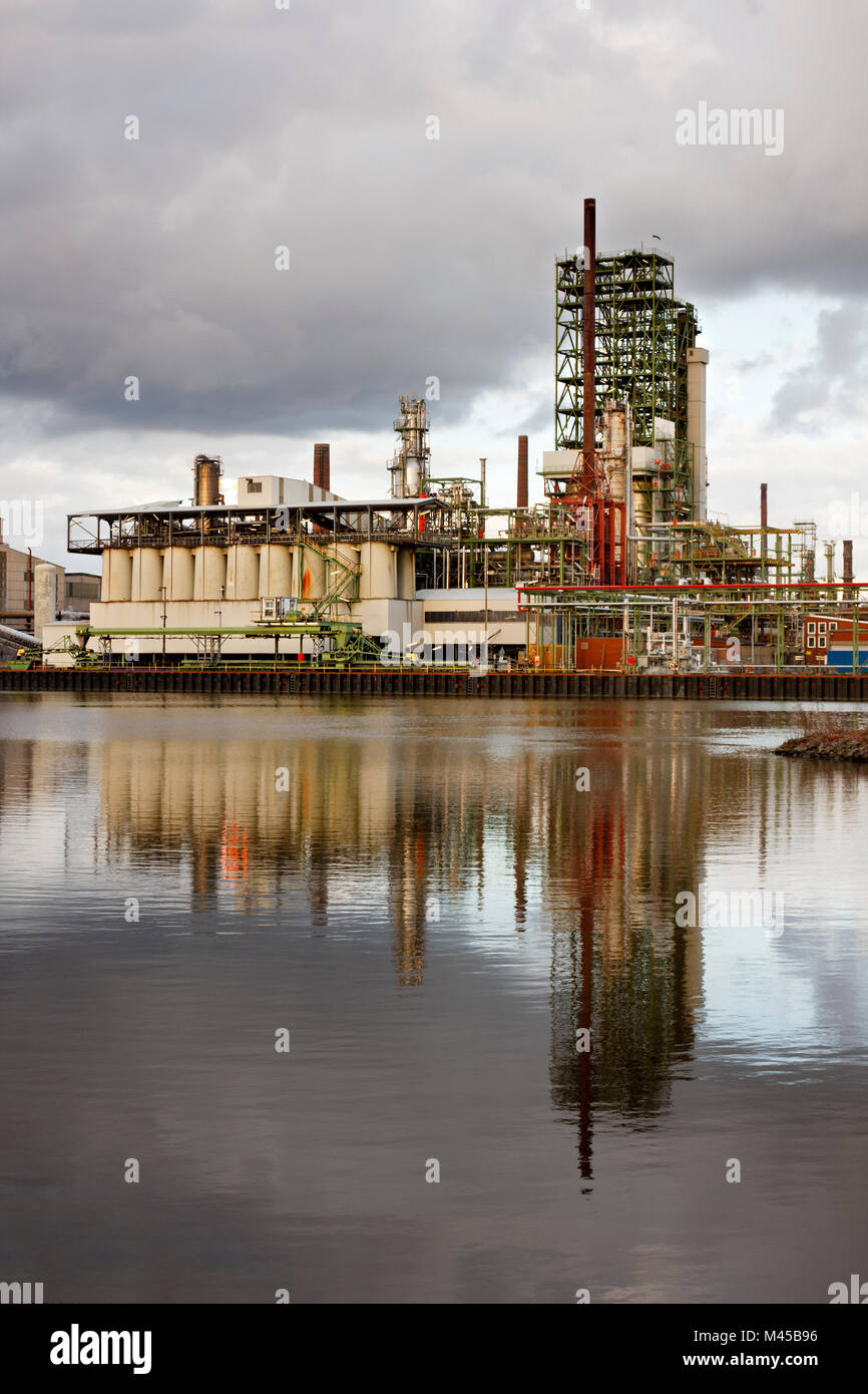 An old oil refinery at a canal Stock Photo - Alamy