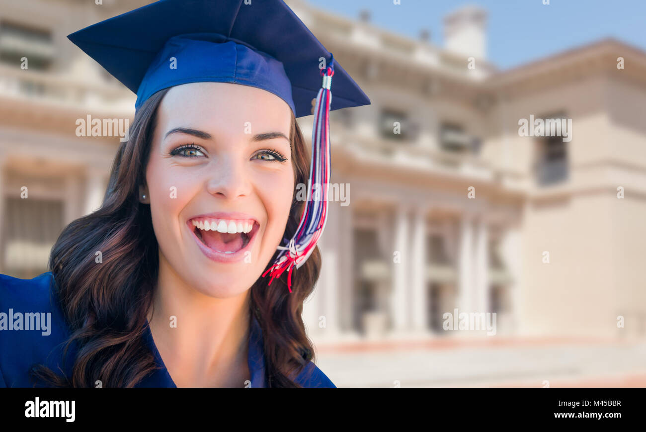 Happy Graduating Mixed Race Woman In Cap and Gown Celebrating on Campus ...