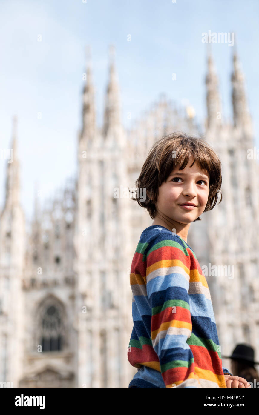 Portrait of boy looking over his shoulder in Milan Cathedral square ...