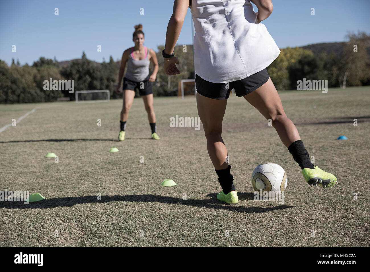 Women on football pitch playing football Stock Photo - Alamy