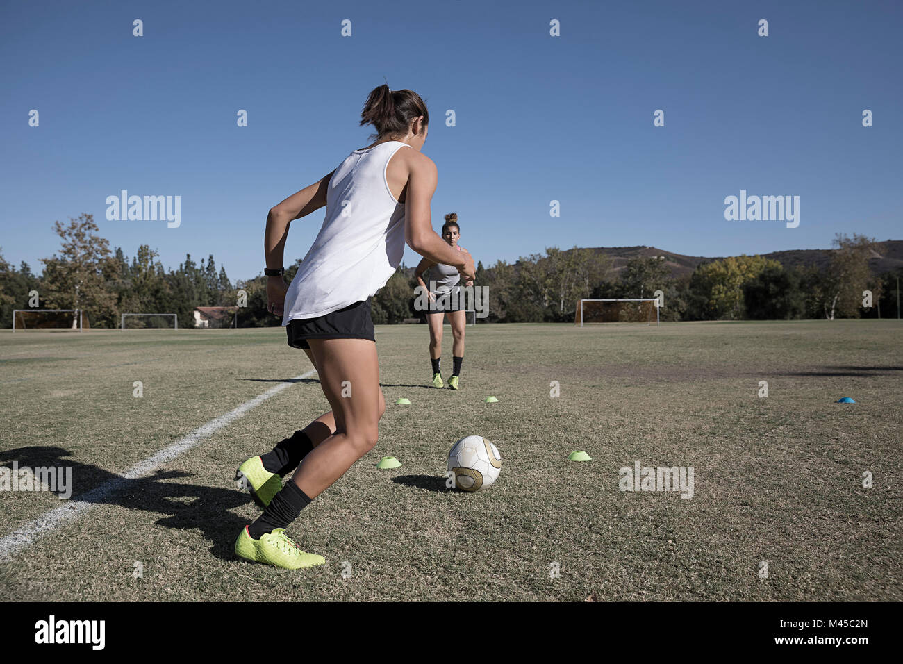 Women on football pitch playing football Stock Photo - Alamy