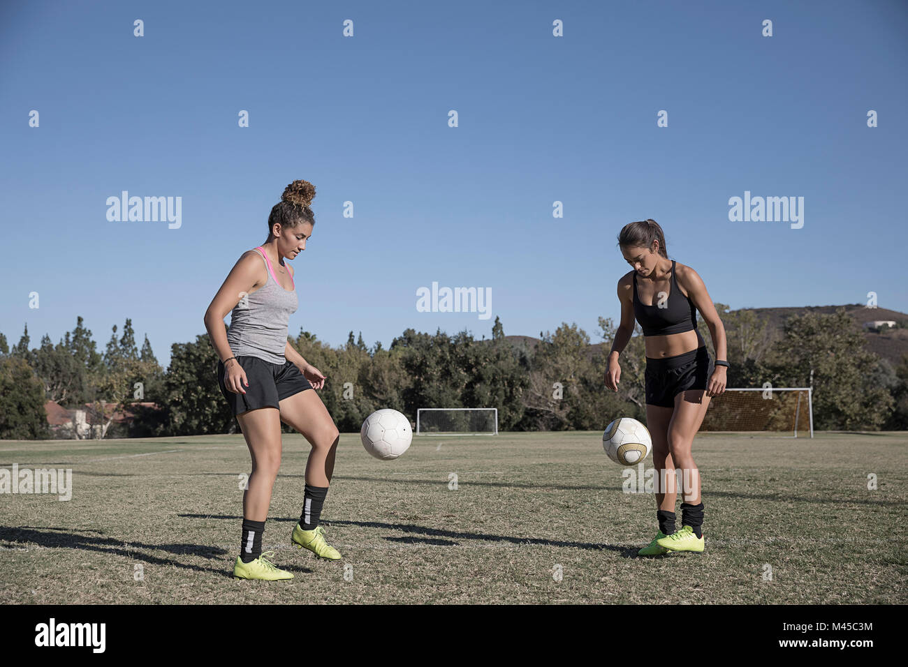 Women on football pitch playing football Stock Photo - Alamy