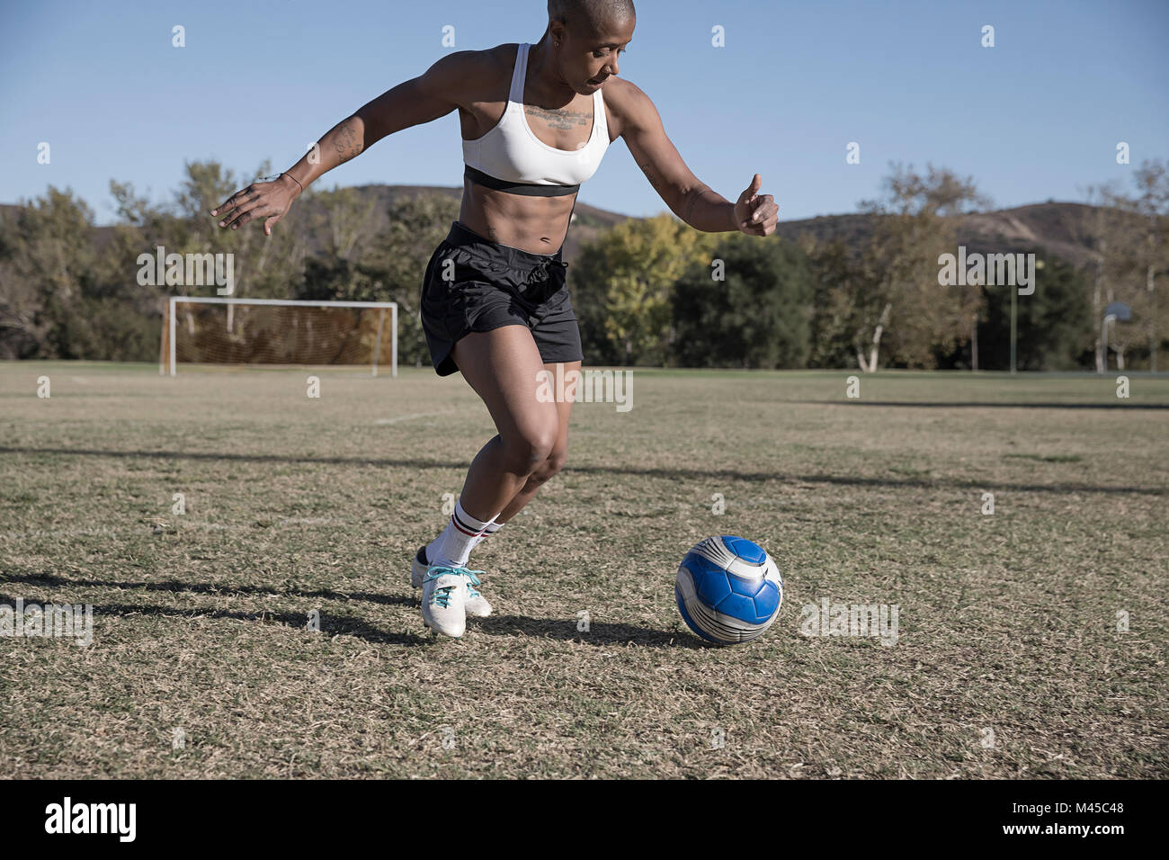 Women on football pitch playing football Stock Photo - Alamy