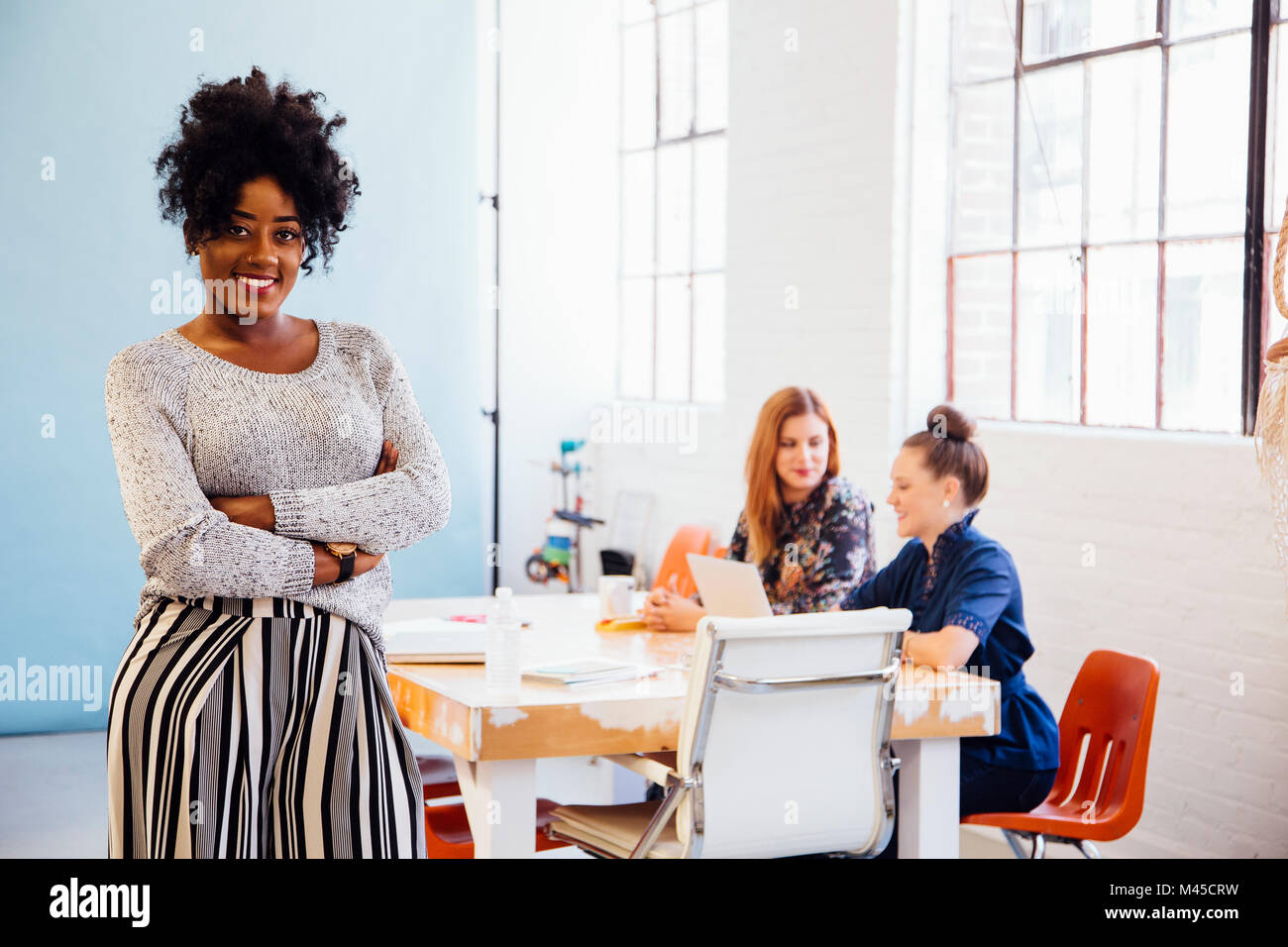 Portrait of woman in office looking at camera smiling Stock Photo - Alamy