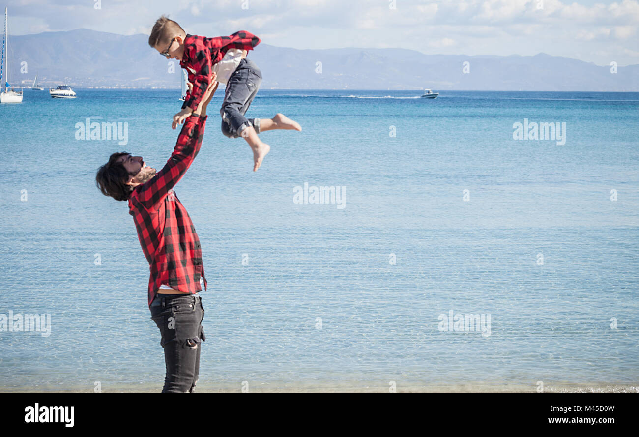 Father lifting son in the air hi-res stock photography and images - Alamy
