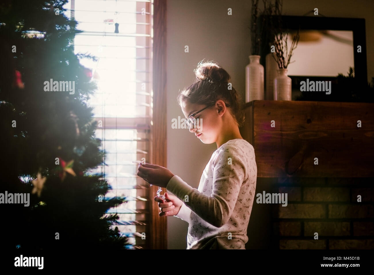 Girls holding christmas decorations hi-res stock photography and images ...