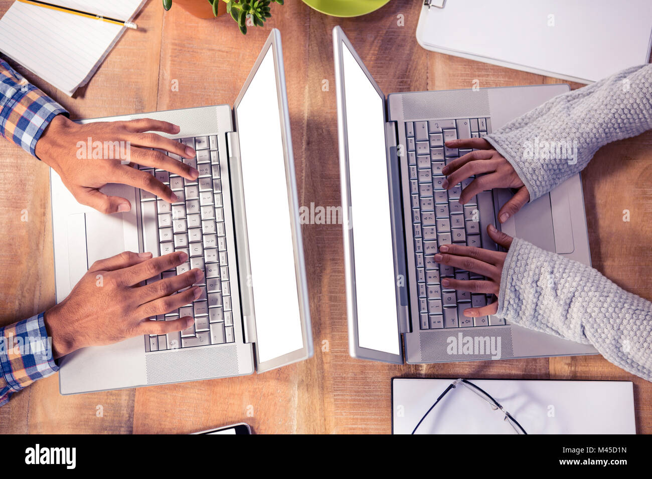 Overhead view of hands typing on laptop keyboard Stock Photo - Alamy