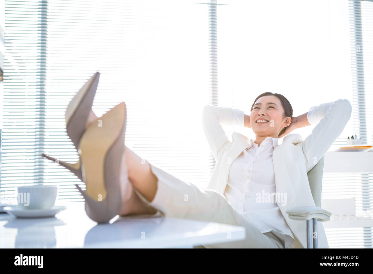 Relaxed businesswoman sitting with her feet up Stock Photo - Alamy