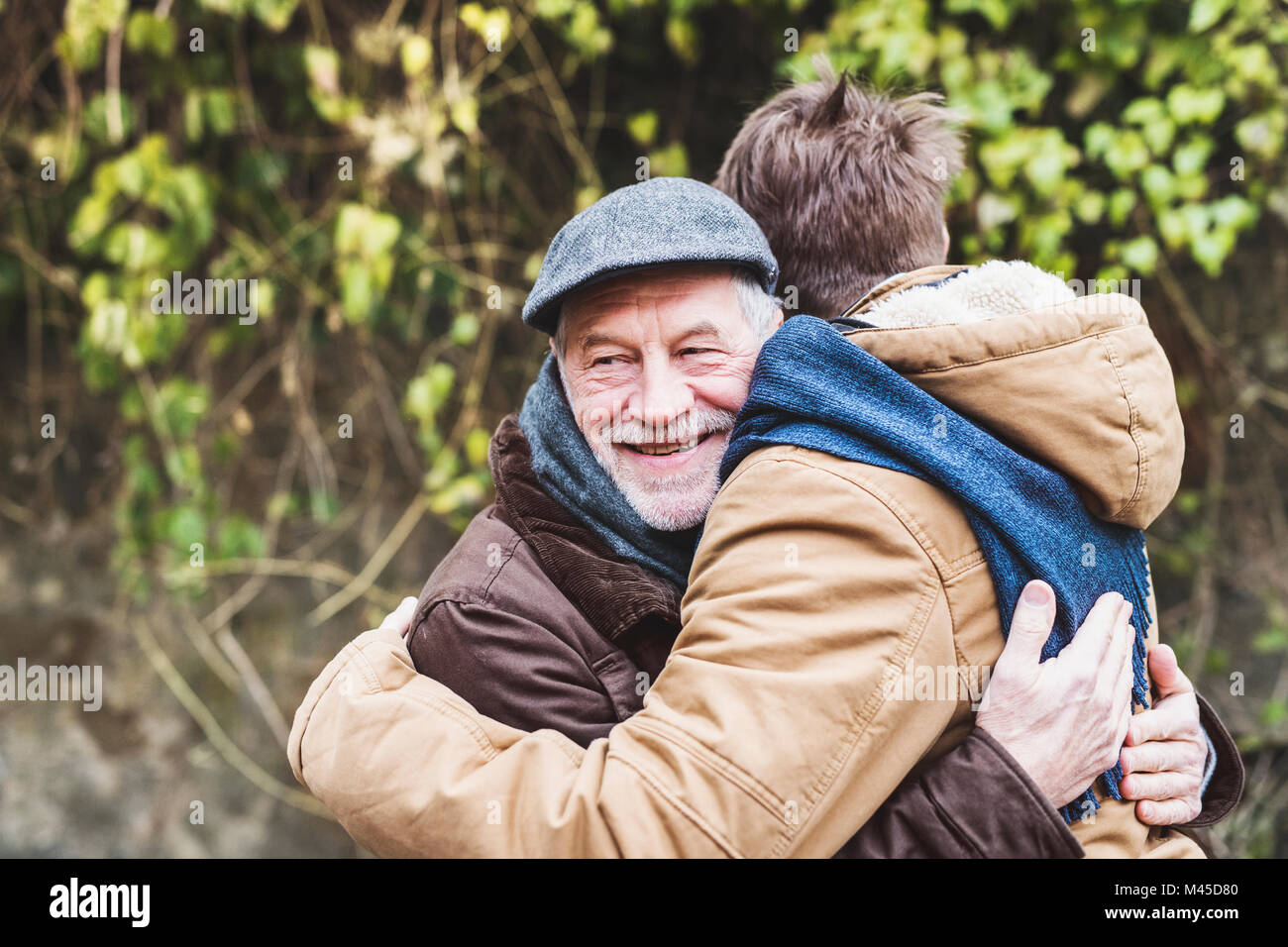 Senior father and his young son on a walk, hugging Stock Photo - Alamy