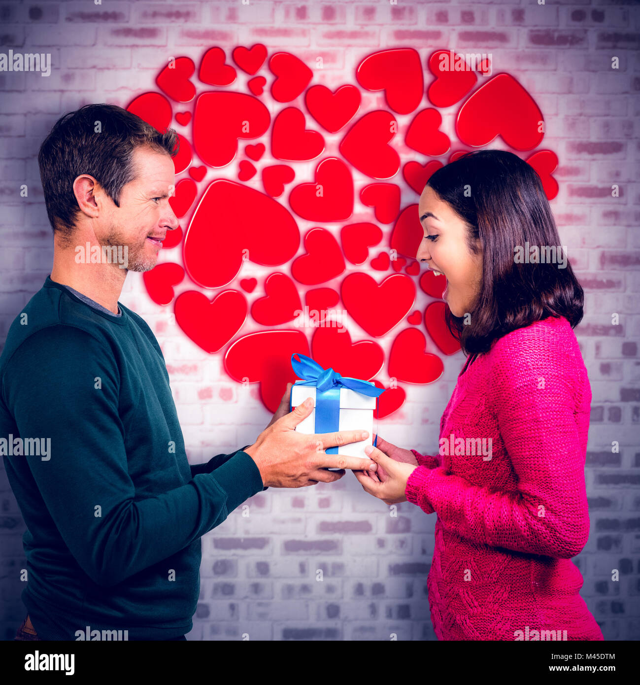 Composite image of excited girlfriend taking gift from boyfriend Stock ...