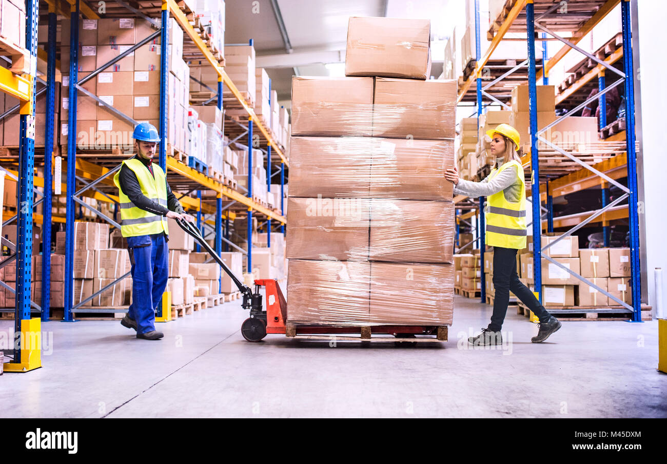 Warehouse pulling pallet truck boxes hi-res stock photography and ...