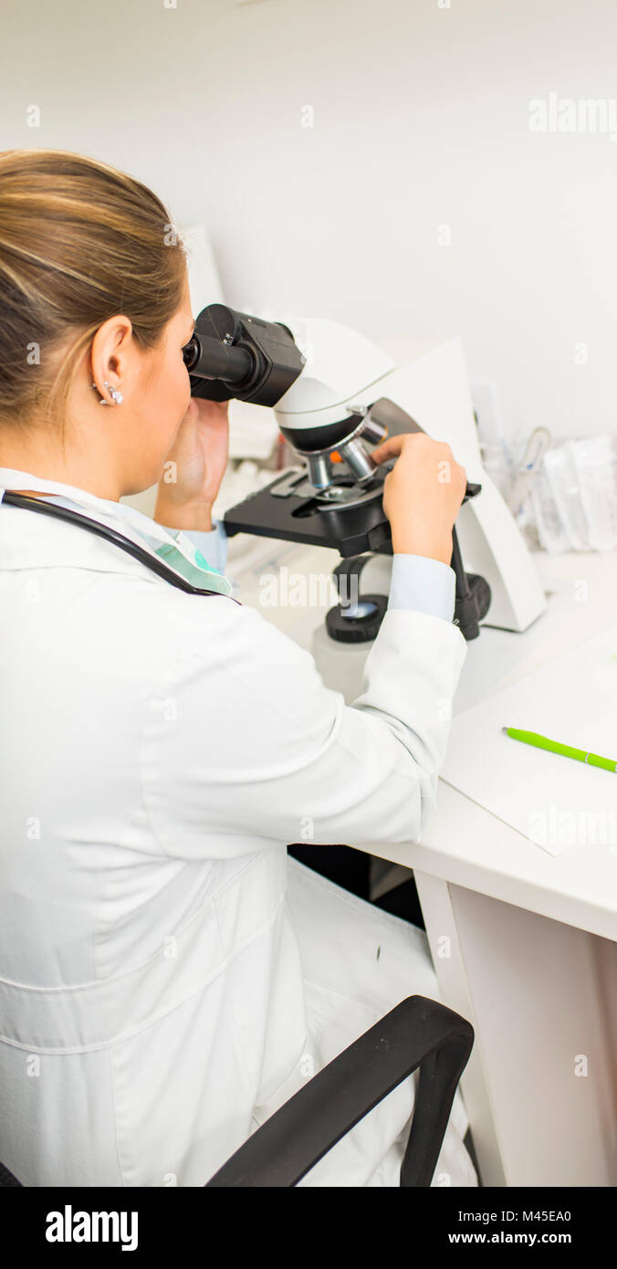 Doctor using a microscope hi-res stock photography and images - Alamy