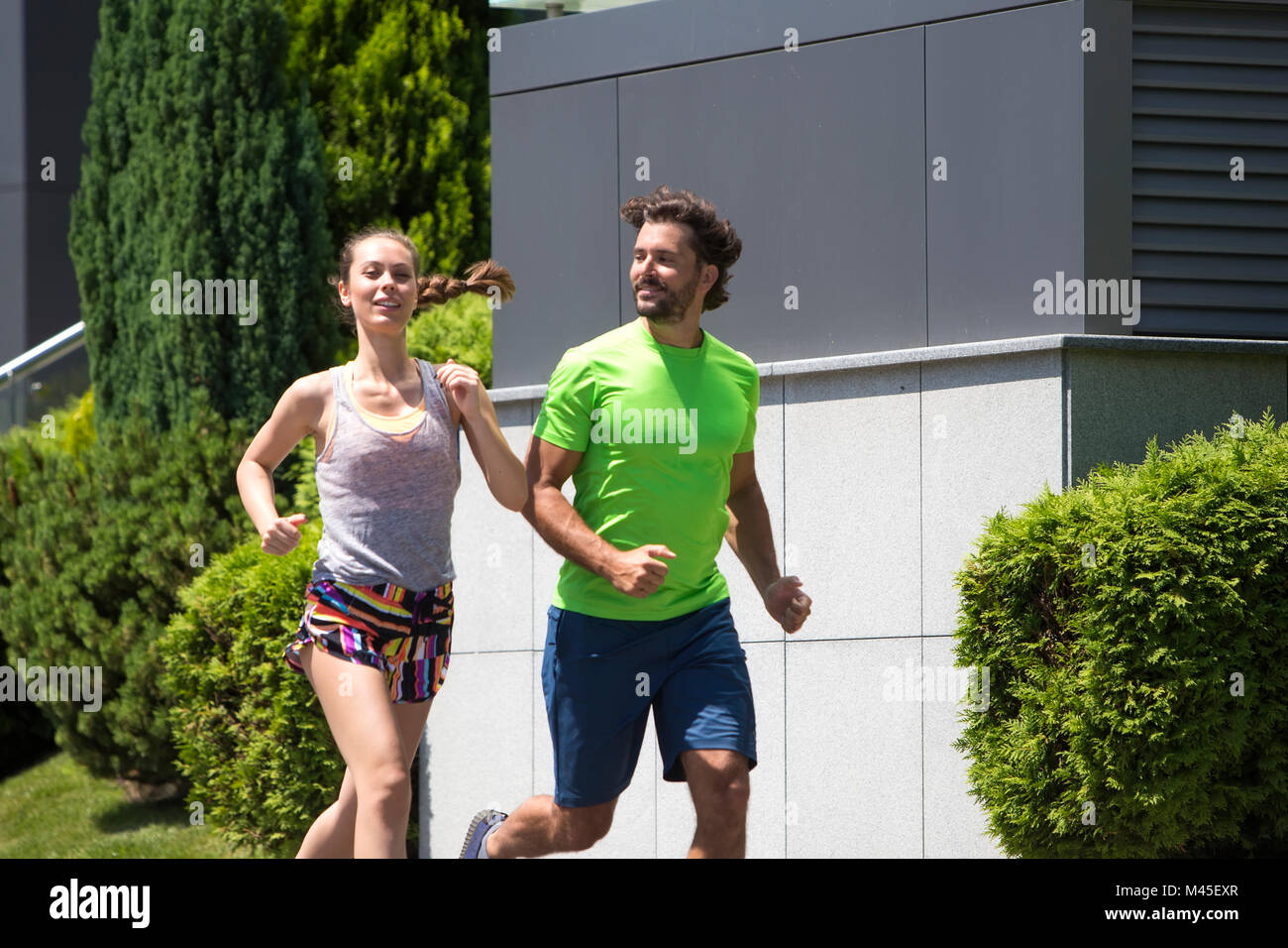 Couple running in urban enviroment at hot summer day Stock Photo - Alamy