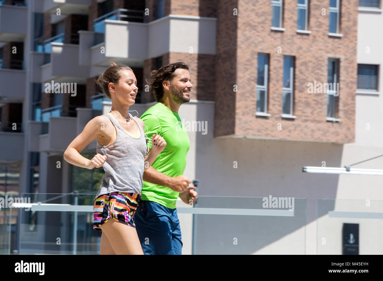 Couple running in urban enviroment at hot summer day Stock Photo - Alamy