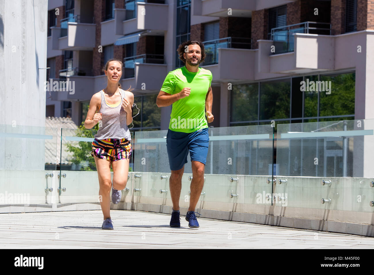 Couple running in urban enviroment at hot summer day Stock Photo - Alamy