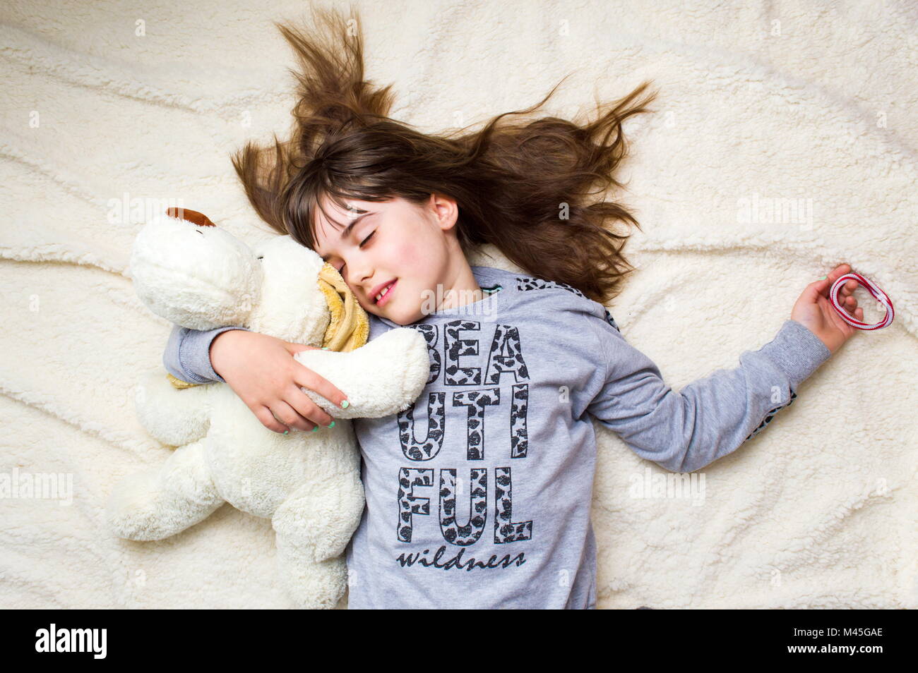 Girl Taking A Nap While Hugging Her Toy Stock Photo Alamy