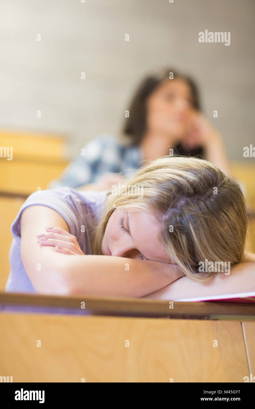 Bored student listening while classmate sleeping Stock Photo - Alamy