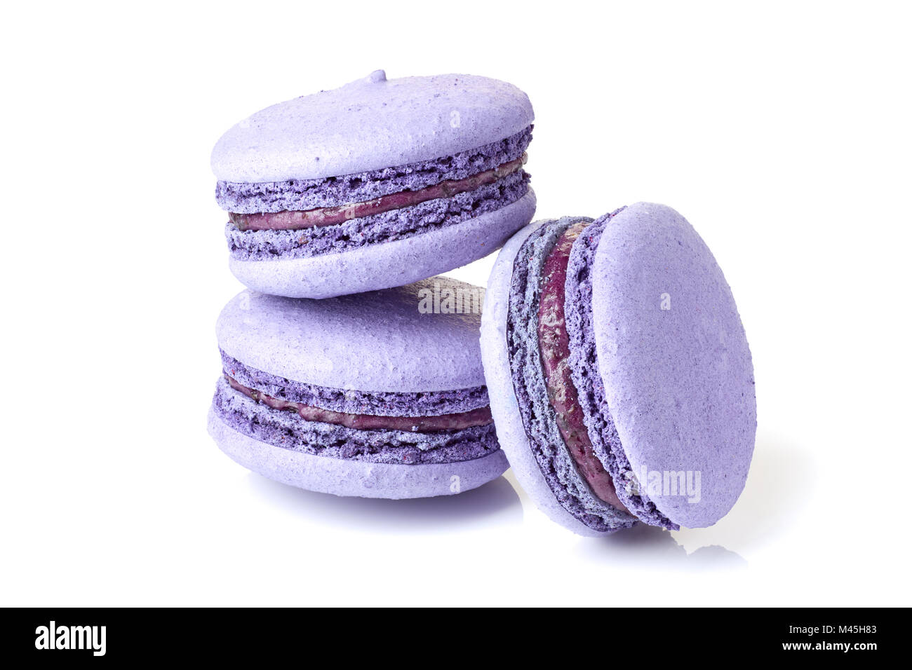 Three violet macarons on white Stock Photo - Alamy