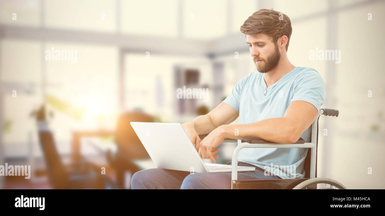Composite image of man in wheelchair using computer Stock Photo - Alamy