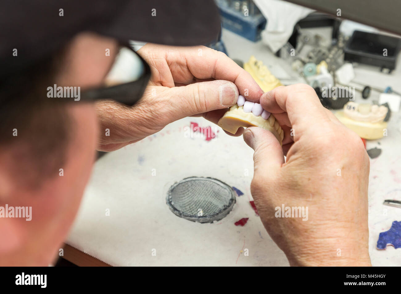 Male Dental Technician Working On A 3D Printed Mold For Tooth Implants ...