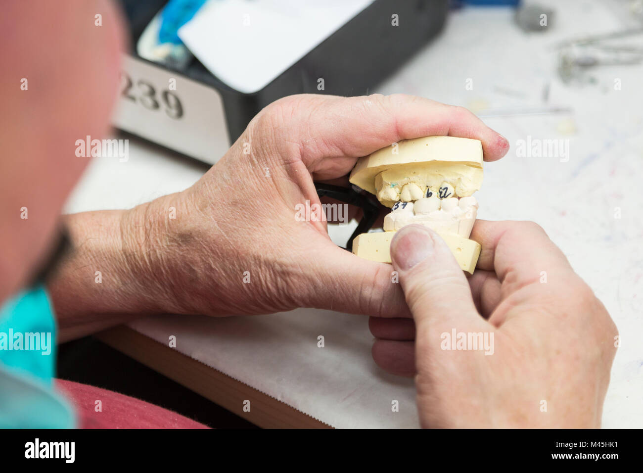 Male Dental Technician Working On A 3D Printed Mold For Tooth Implants ...
