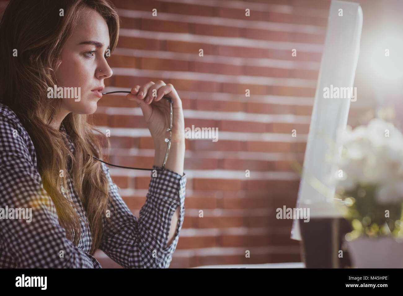 Thoughtful hipster businesswoman watching computer Stock Photo - Alamy