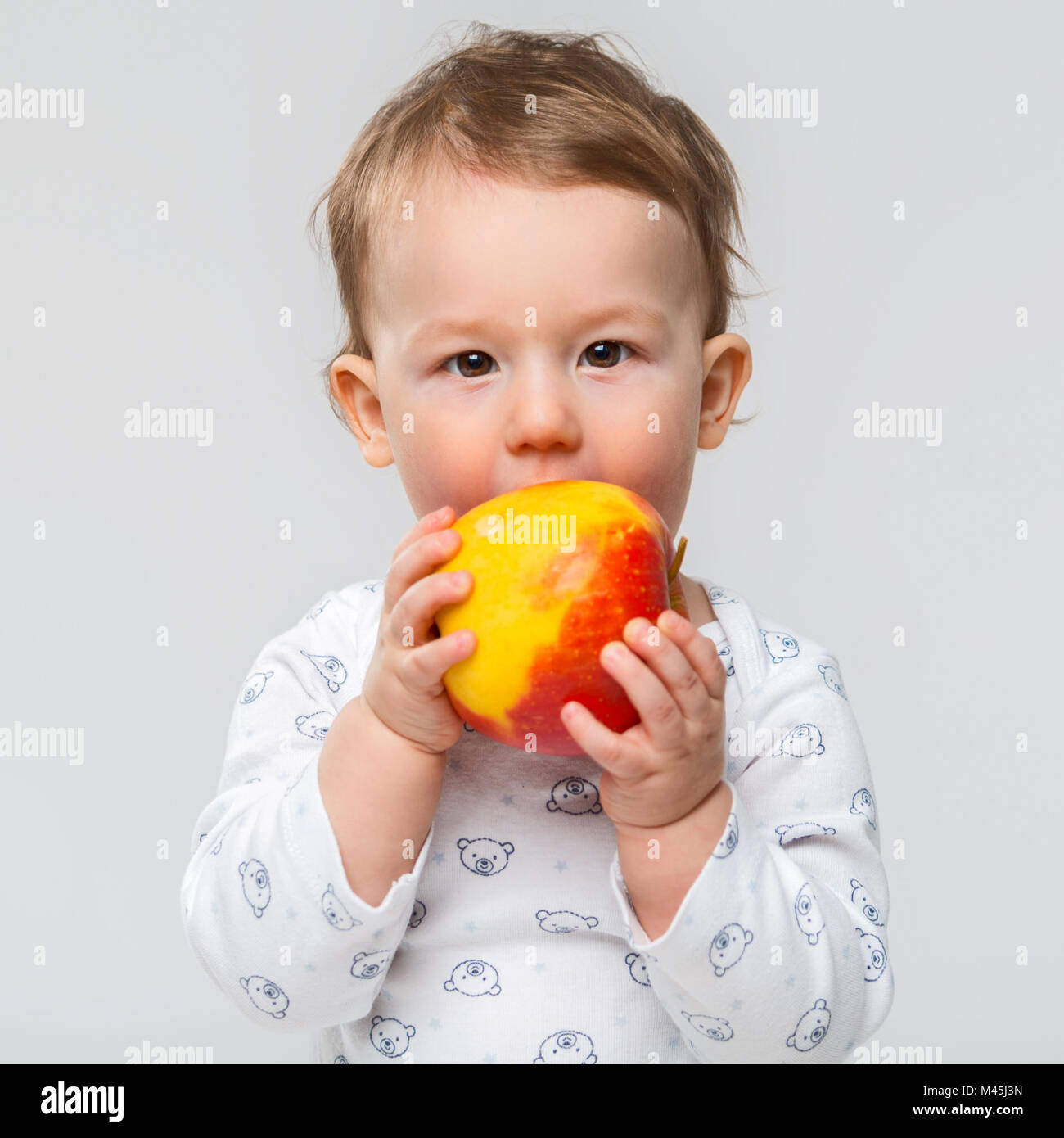 Portrait of a happy little child with an apple in his hands Stock Photo ...