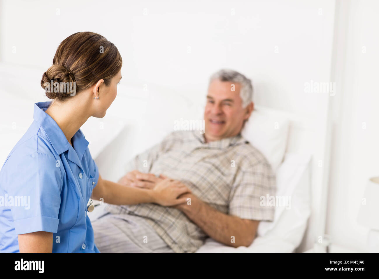 Nurse taking care of suffering senior patient Stock Photo - Alamy