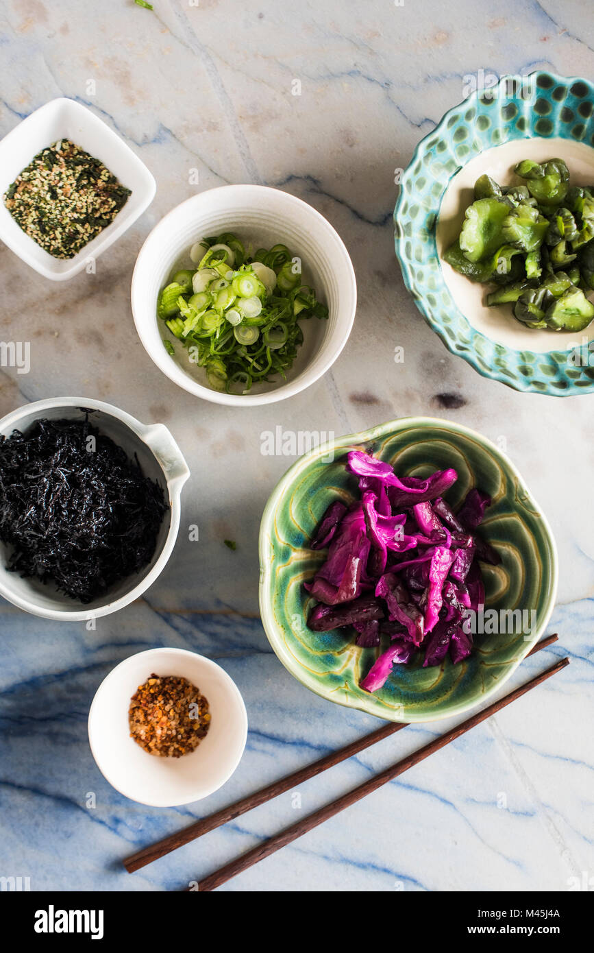 Poke ingredients in bowls Stock Photo - Alamy